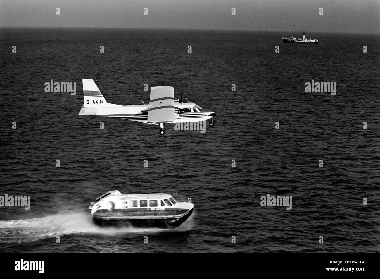 Islander aircraft flies over Cushion Craft Hovercraft, off the Isle of ...