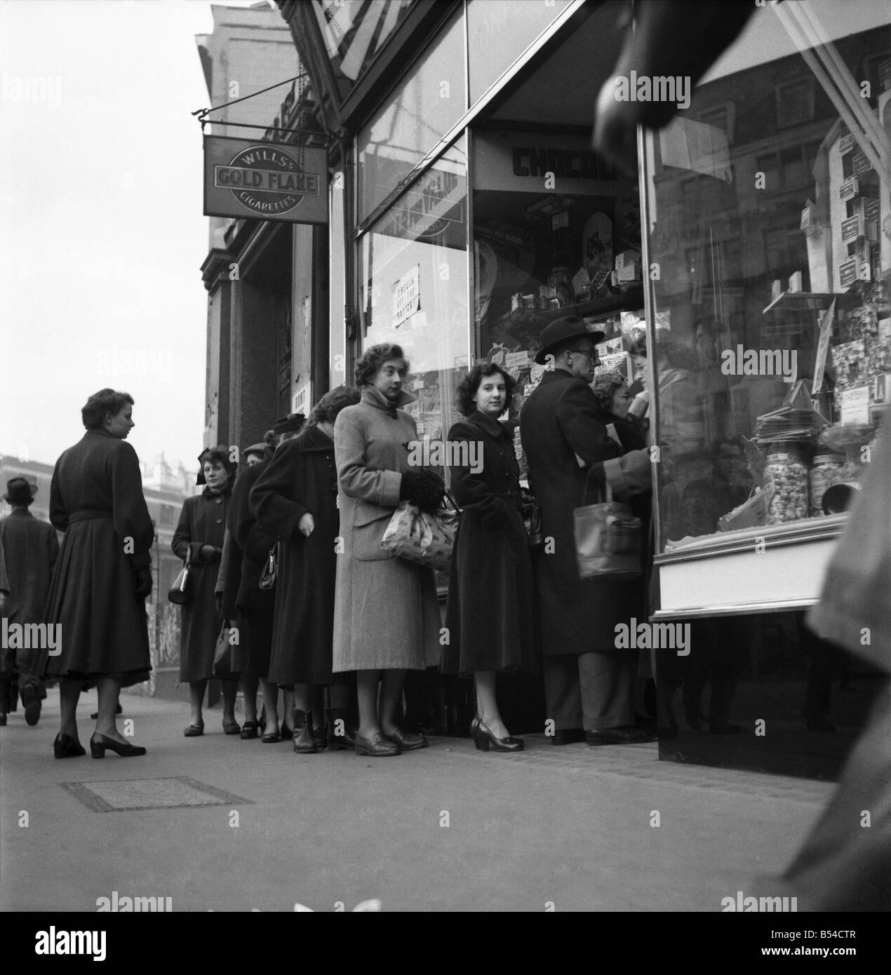 People queuing up outside a confectioney shop after sweets came off the ...