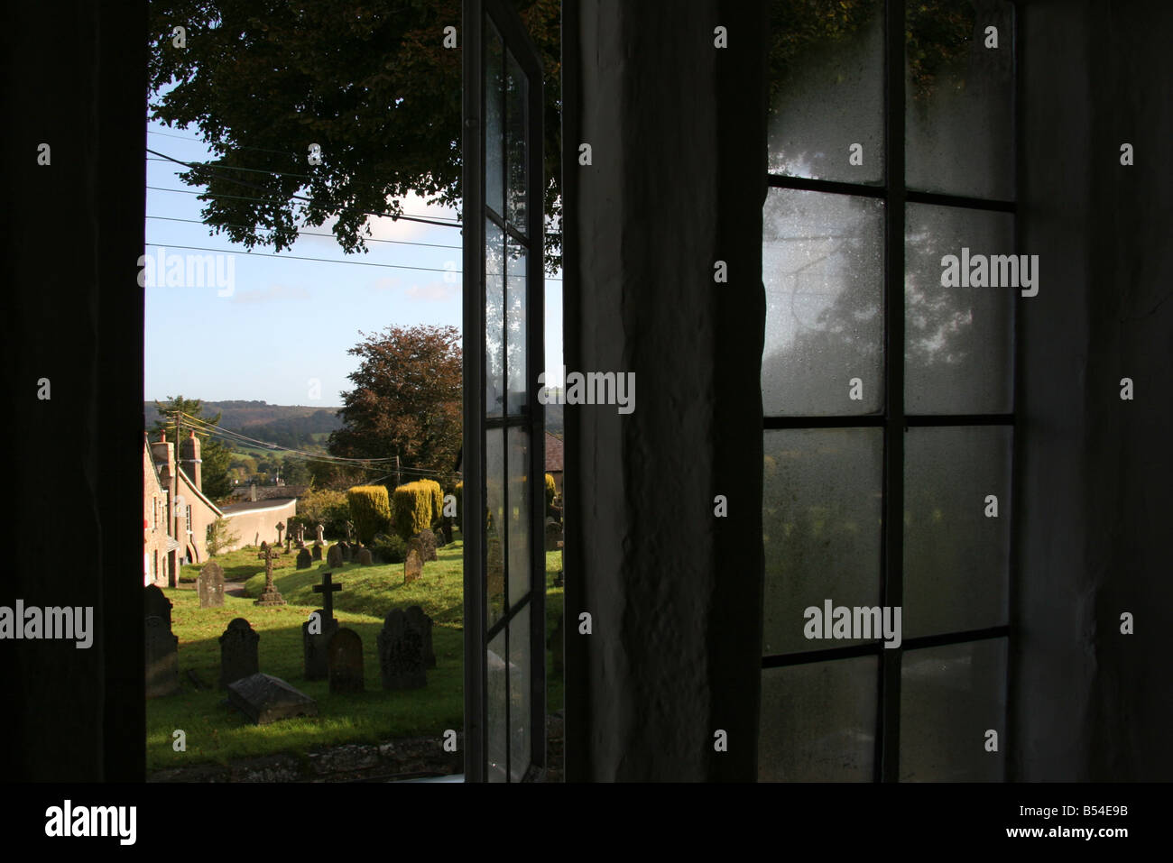 Looking through an old window towards an old graveyard at Chagford ...