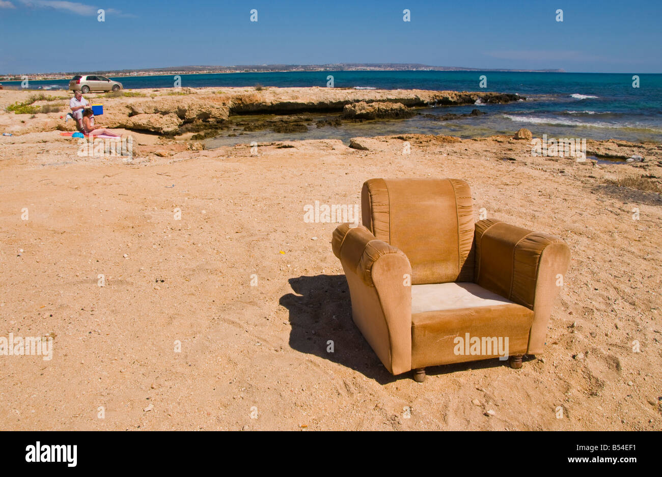 Old easy chair dumped on beach near Ayia Napa on the Mediterranean ...