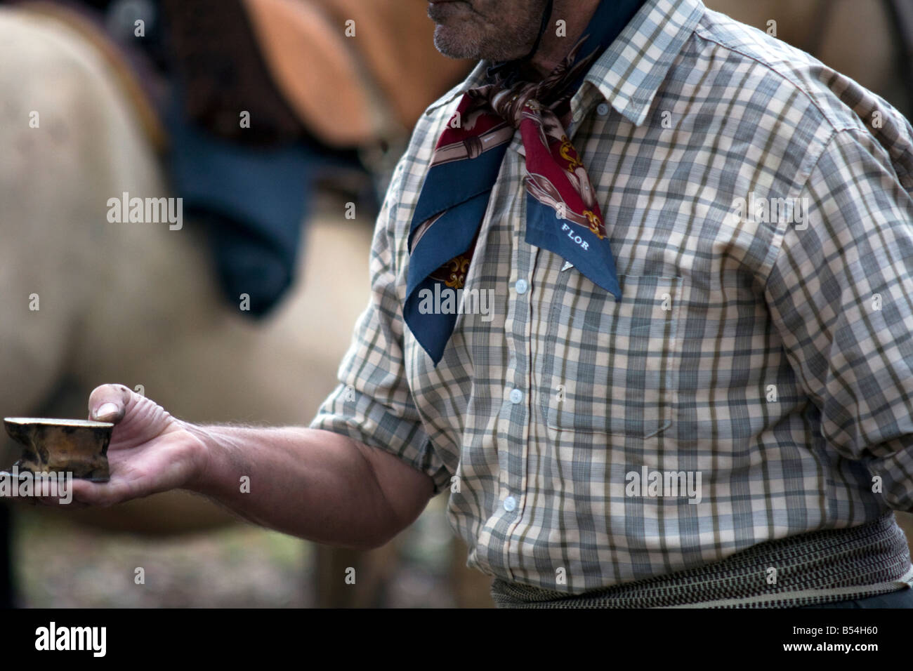 A gaucho prepares to throw a taba whilst playing the traditional game ...