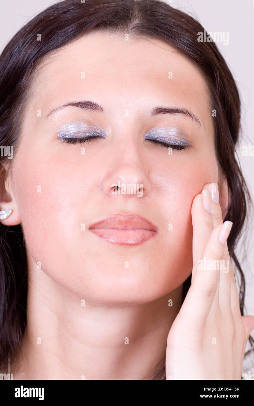 Beautiful woman touching face Stock Photo - Alamy