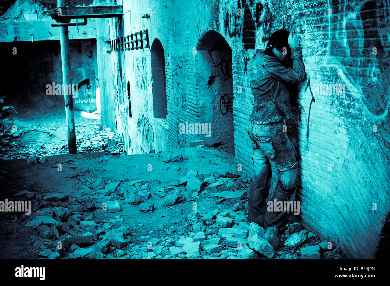 Tormented young woman crying over brickwall Stock Photo - Alamy