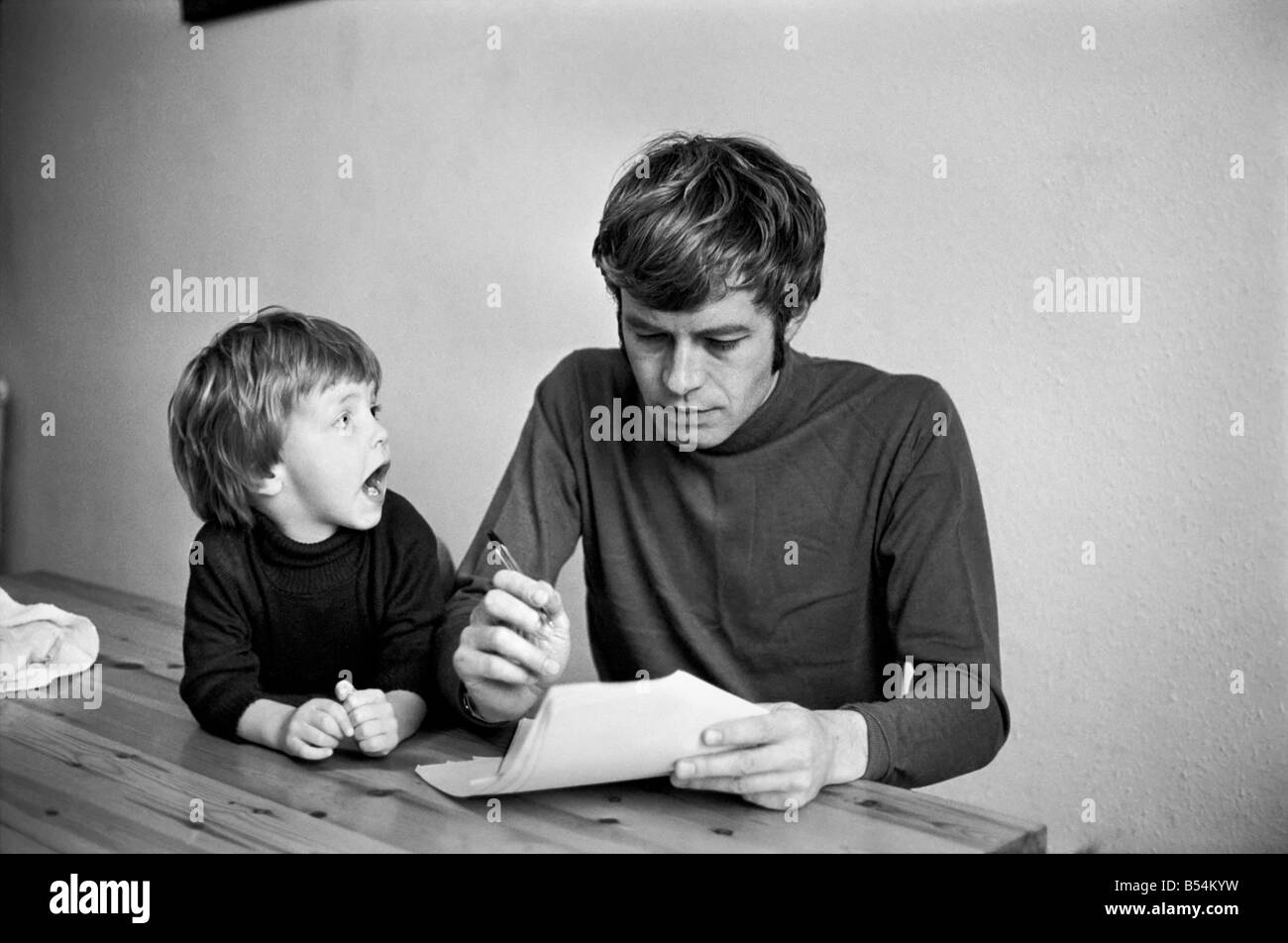 Families: Mother, father and children. Father and son writing with pen ...