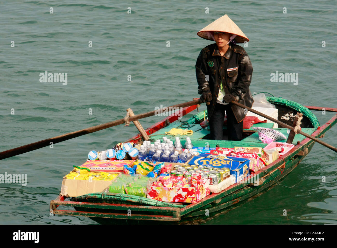 Woman selling goods from a boat in Halong Bay, Gulf of Tonkin, Vietnam ...