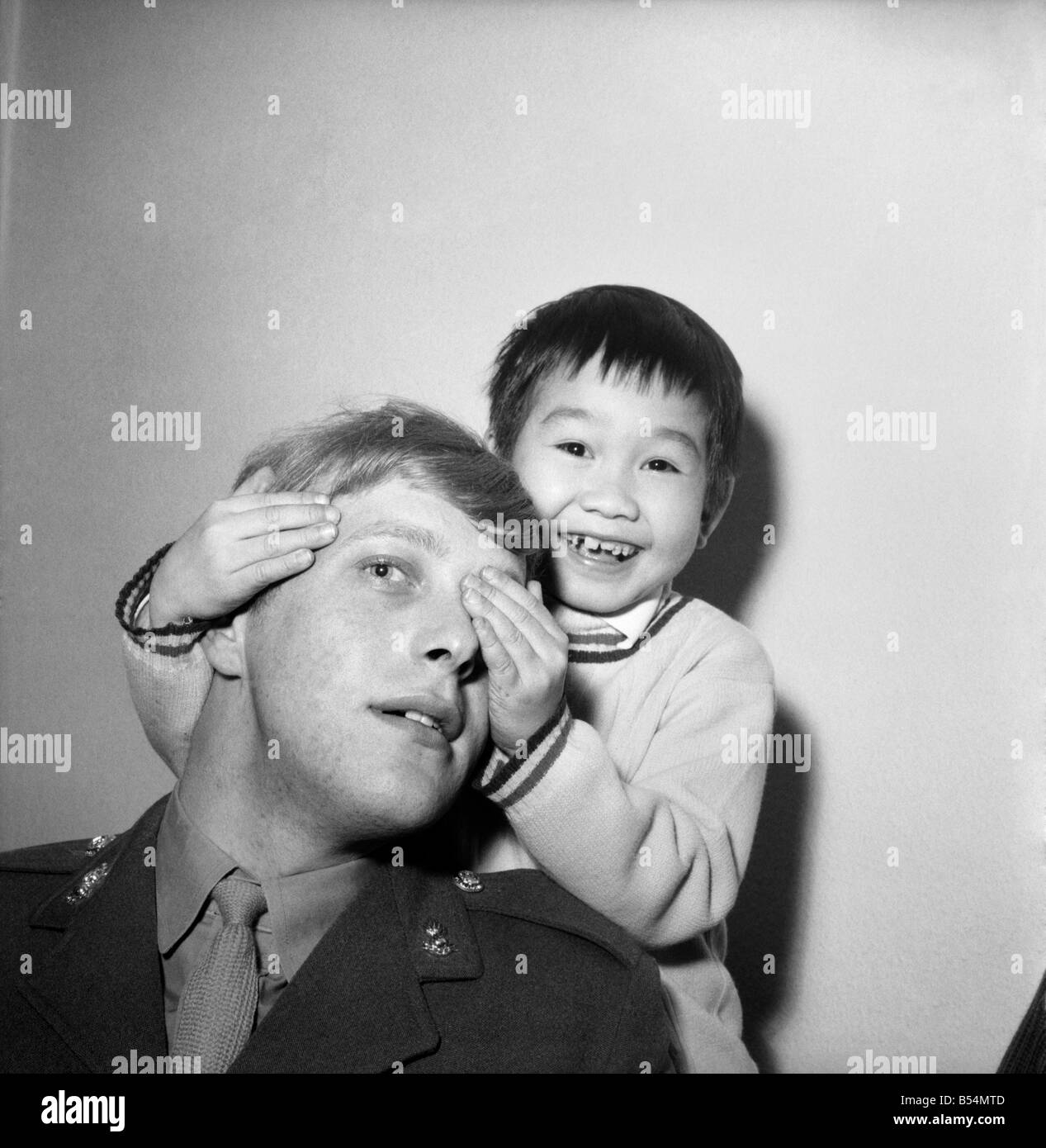 Vietnamese child playing with a British soldier in Peaceville, West ...