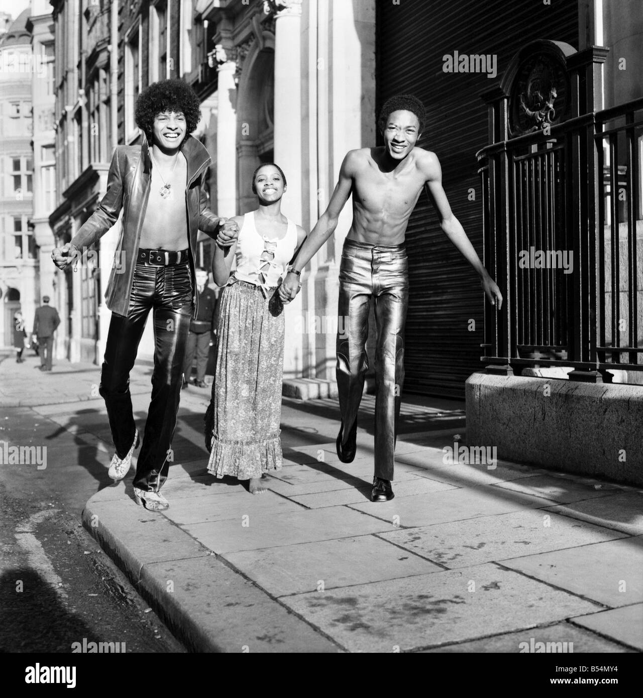Black teenage boys and girls wearing fashion during a photo shoot ...