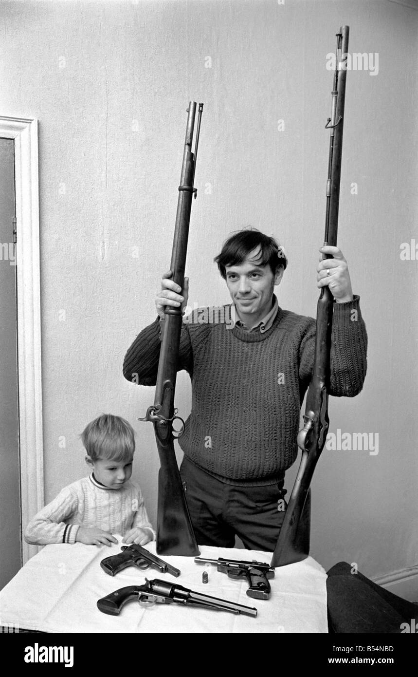 Brian Entwistle with his son, Nigel (5) and his collection of guns - a ...