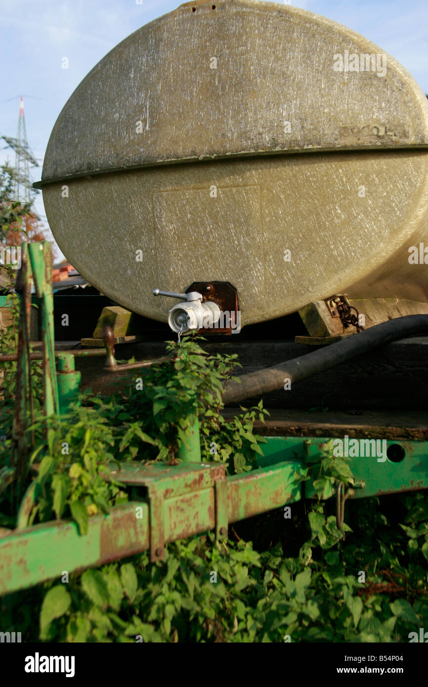 overgrown water tank Stock Photo - Alamy