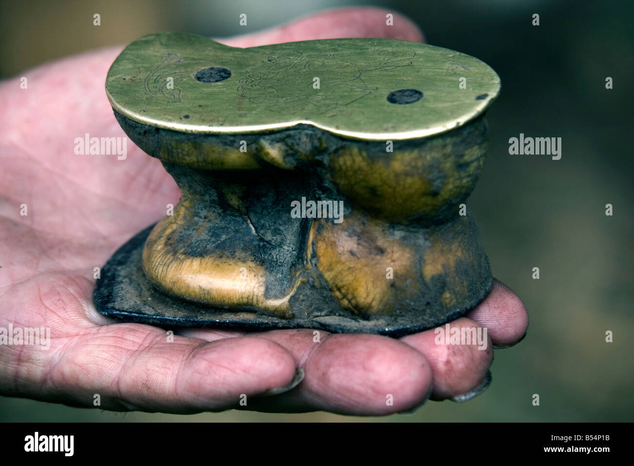 A gaucho holds a taba which is used to play the traditional game of the ...