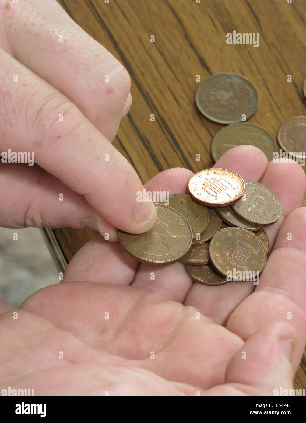 man counting the pennies Stock Photo - Alamy
