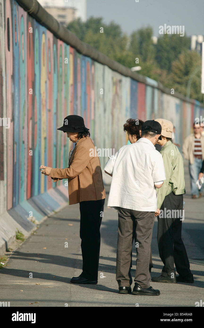 The Berlin Wall and Asian tourists, Germany Stock Photo - Alamy