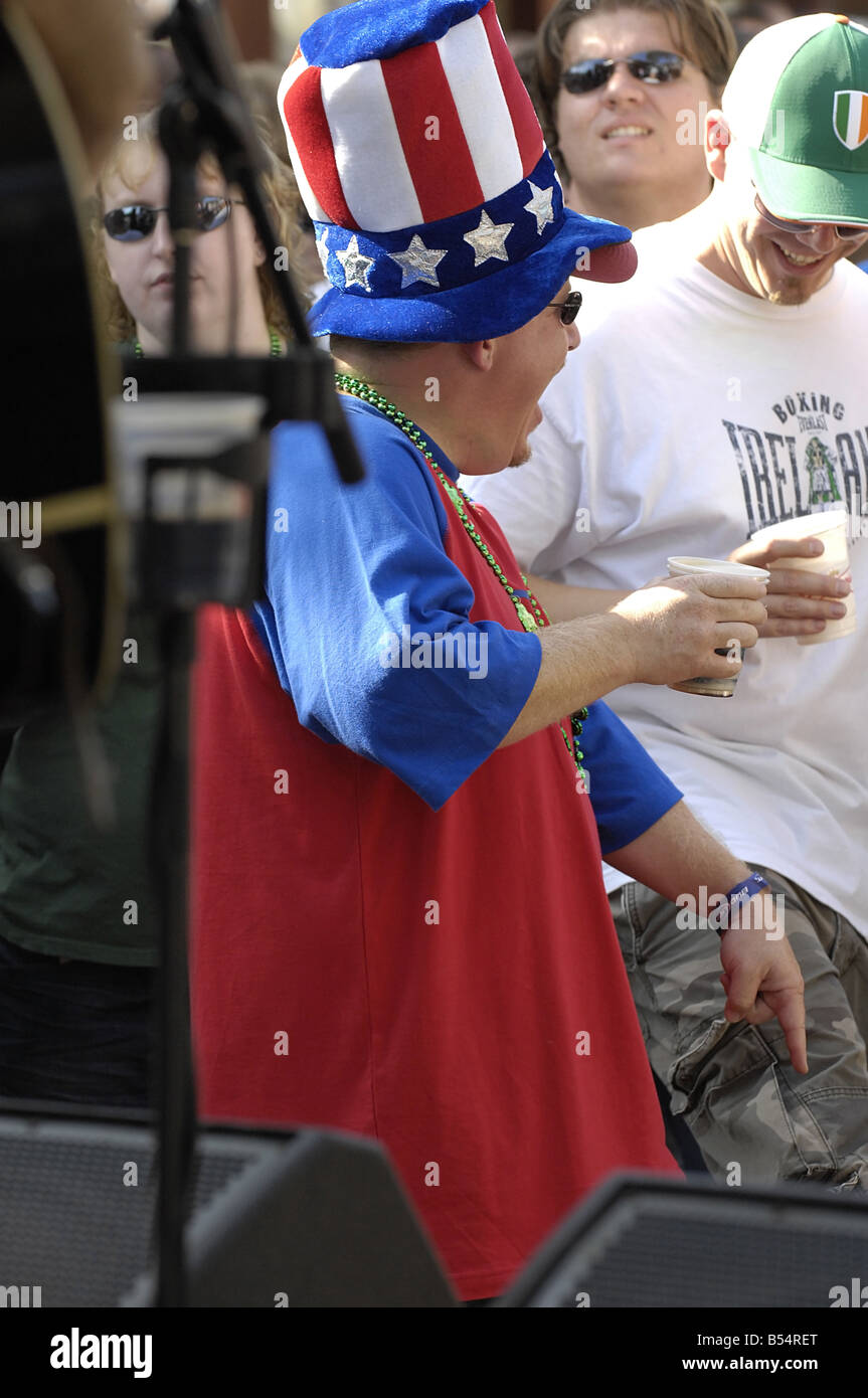 A man dressed in a silly outfit looks like a comical Uncle Sam as he ...