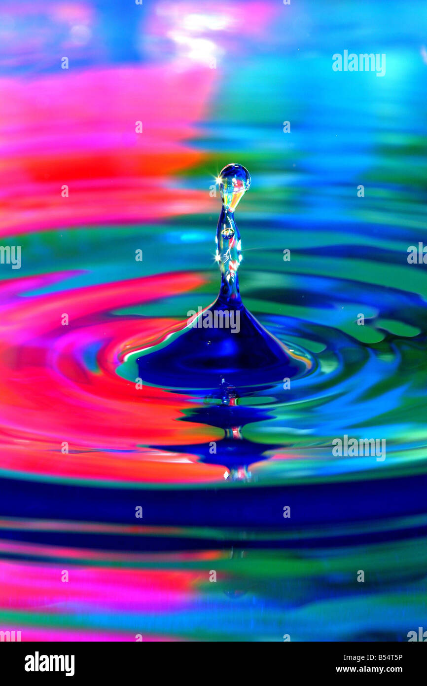 A color drop of water creates a splash Stock Photo - Alamy