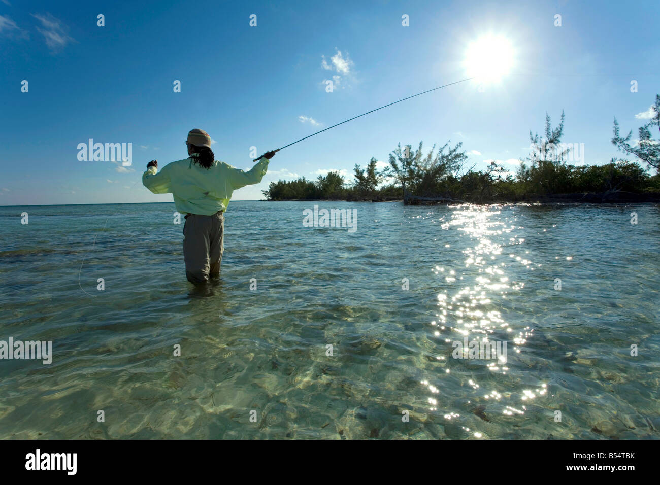 Bonefishing guide Shawn Leadon fishing for bonefish in shallow waters ...