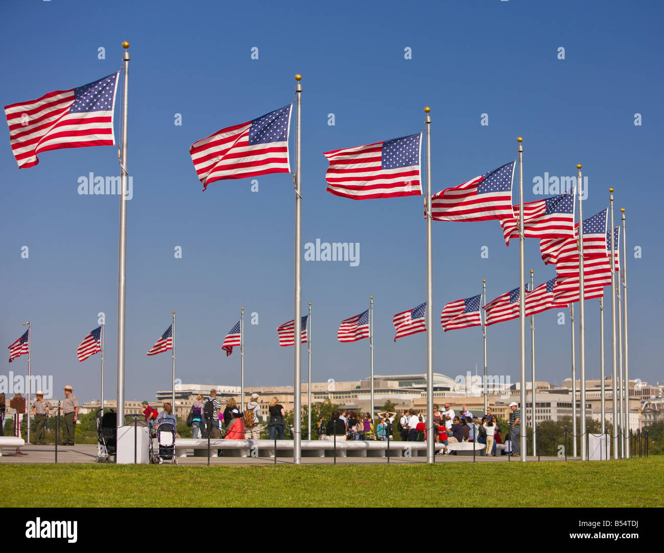 WASHINGTON DC USA Tourists and United States flags flying on flagpoles ...