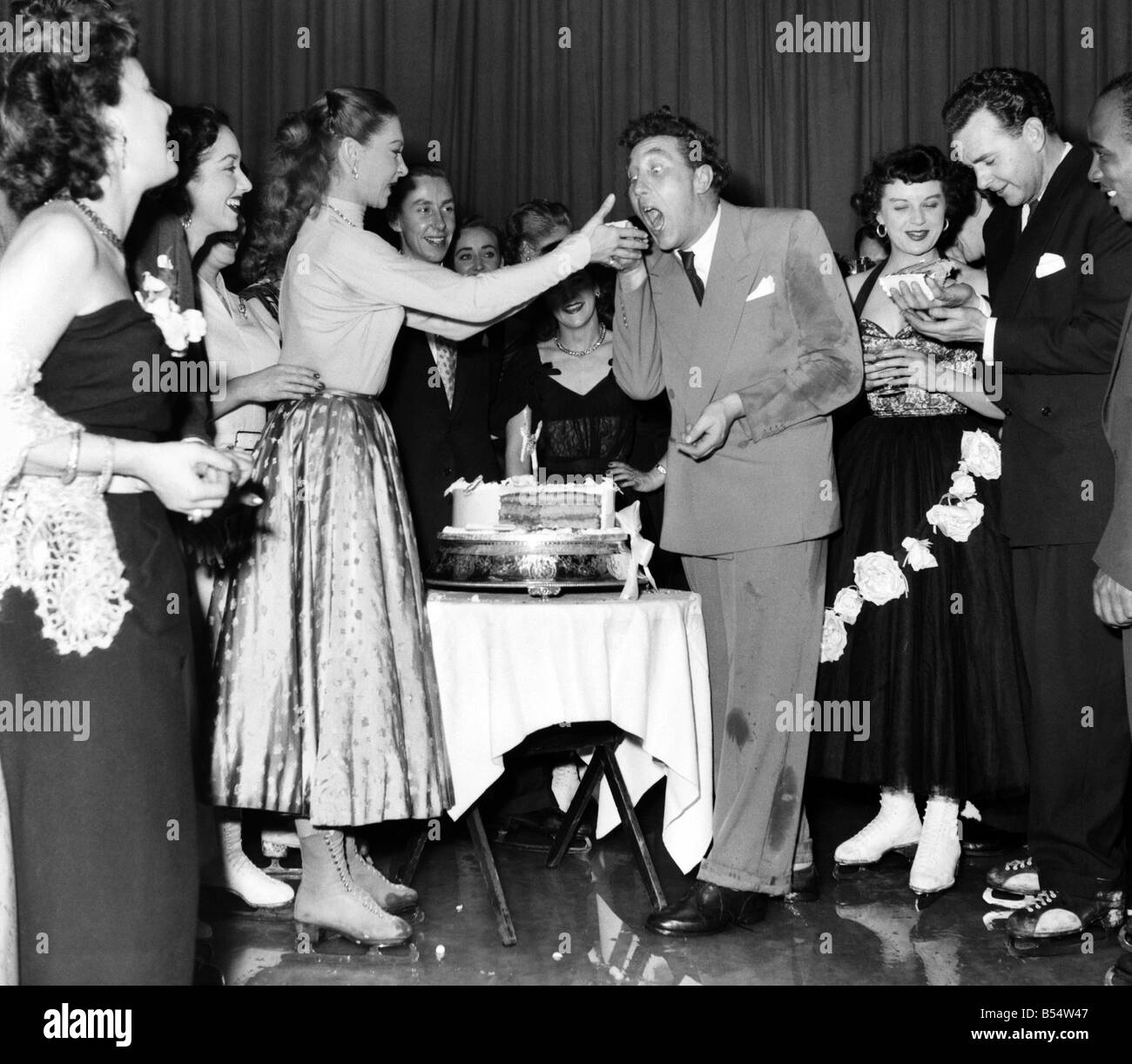 Frankie Howard tries skating with Jane Conlon, of Earls Court, who is a ...