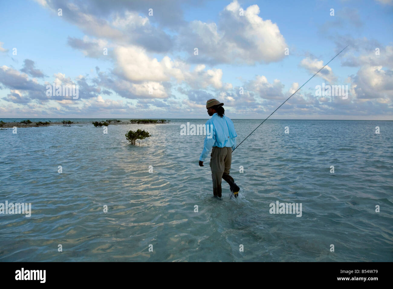 Bonefishing guide Shawn Leadon fishing for bonefish in shallow waters ...
