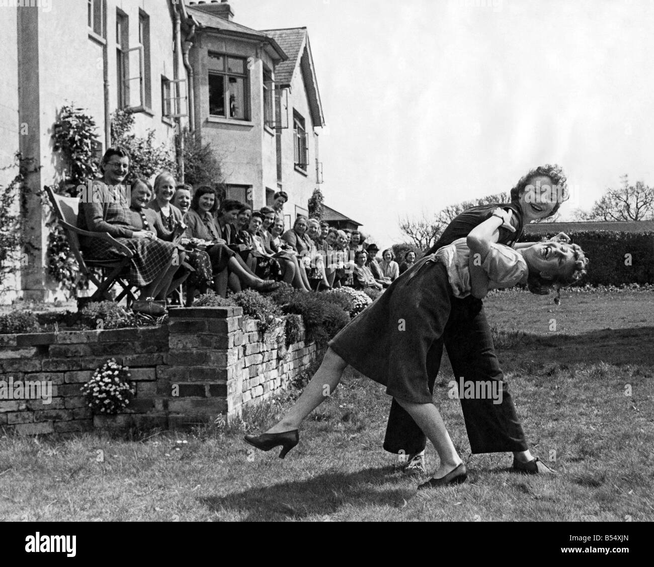 World War II: Women. Women munitions workers dance the jitterbug at a ...
