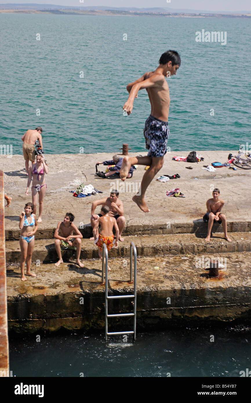 children jumping from the pier Stock Photo - Alamy