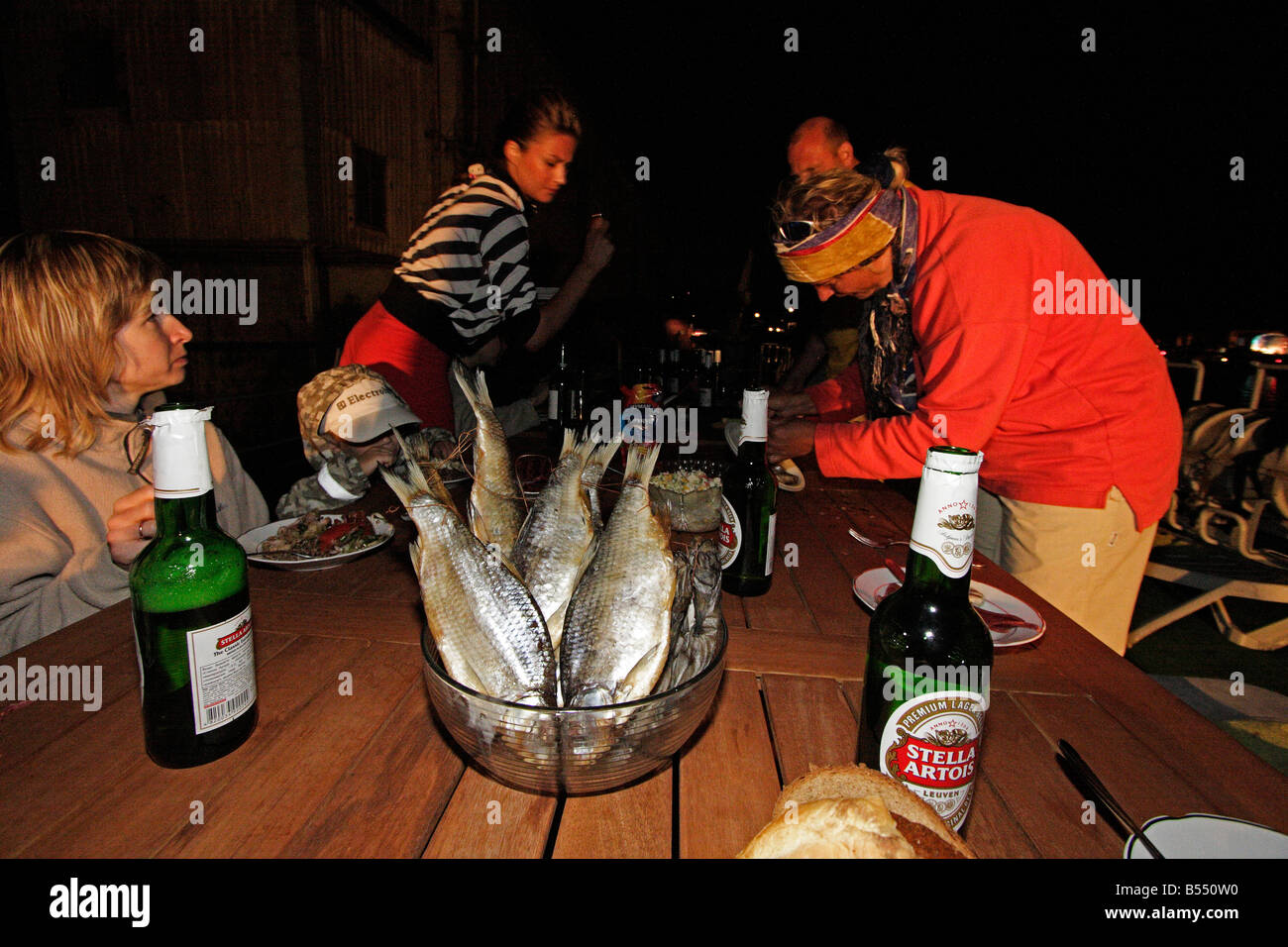 people eating stockfish Stock Photo - Alamy