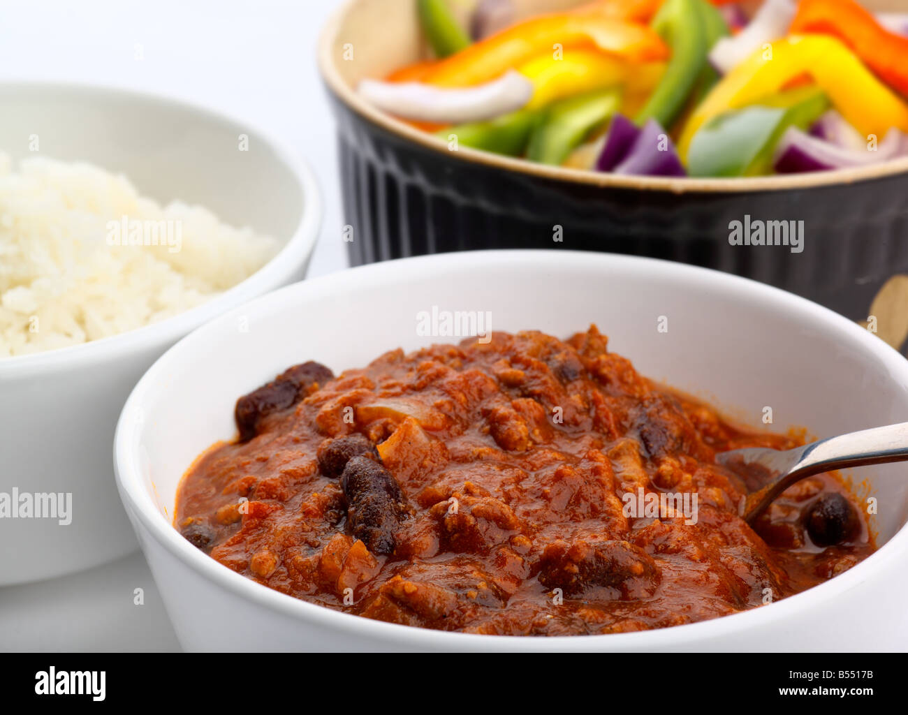 Chilli con carne with salad and rice Stock Photo - Alamy