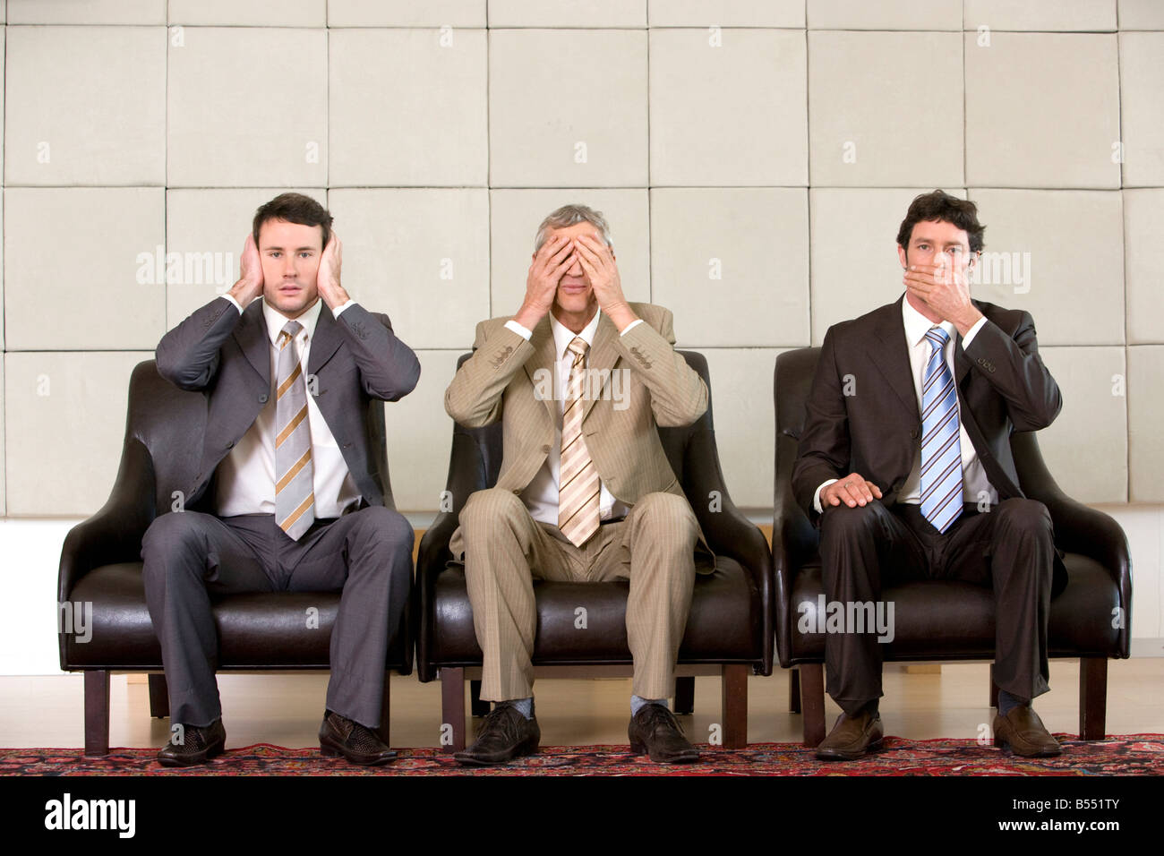 Three businessmen seated demonstrating the "Three Evils Stock Photo - Alamy