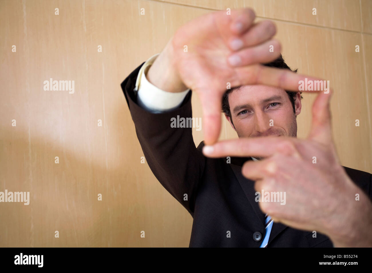 Young businessman looking through a frame created by his fingers Stock ...
