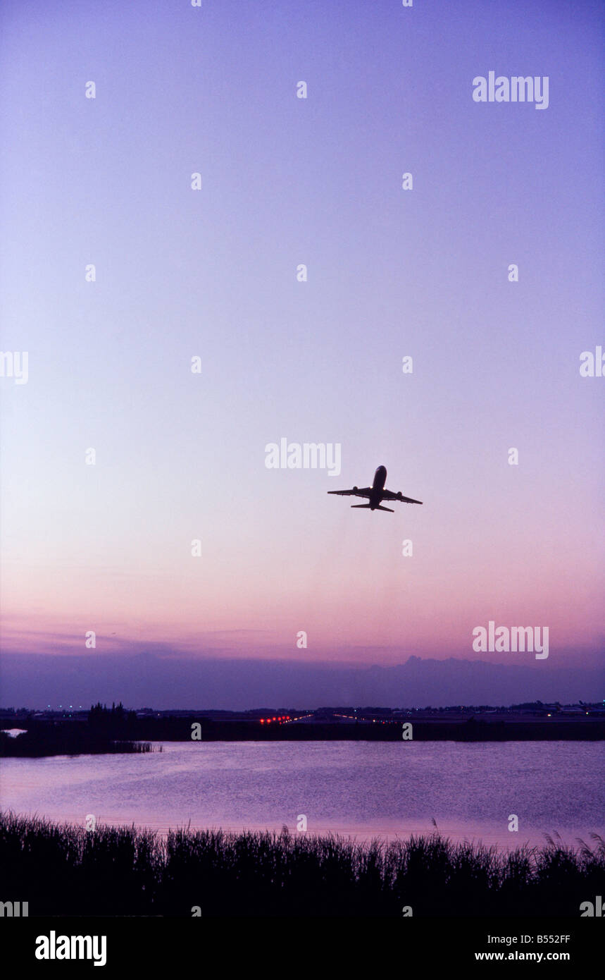 Commercial Airliner takeoff at dusk, Miami International Airport Stock ...