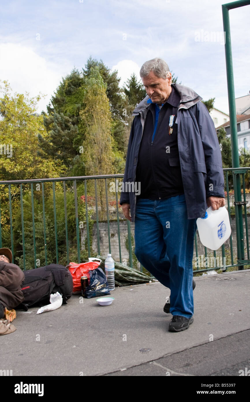 Man on the way to fill holy water, but ignoring the homeless man on the ...