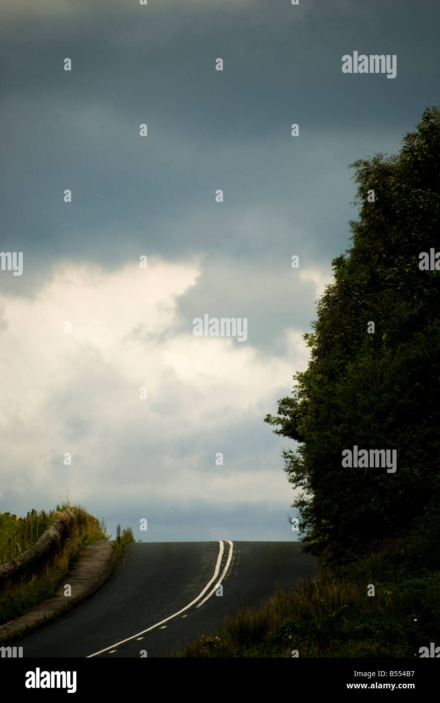 road disappearing over crest of hill Stock Photo - Alamy