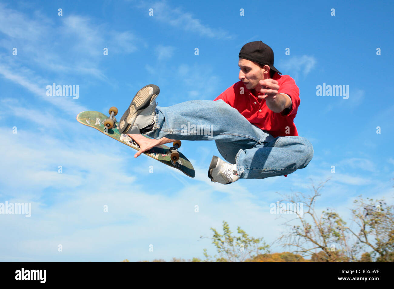young man jumping with his skateboard Stock Photo - Alamy