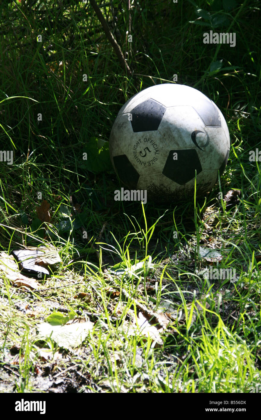 one dirty football in field in sun Stock Photo - Alamy