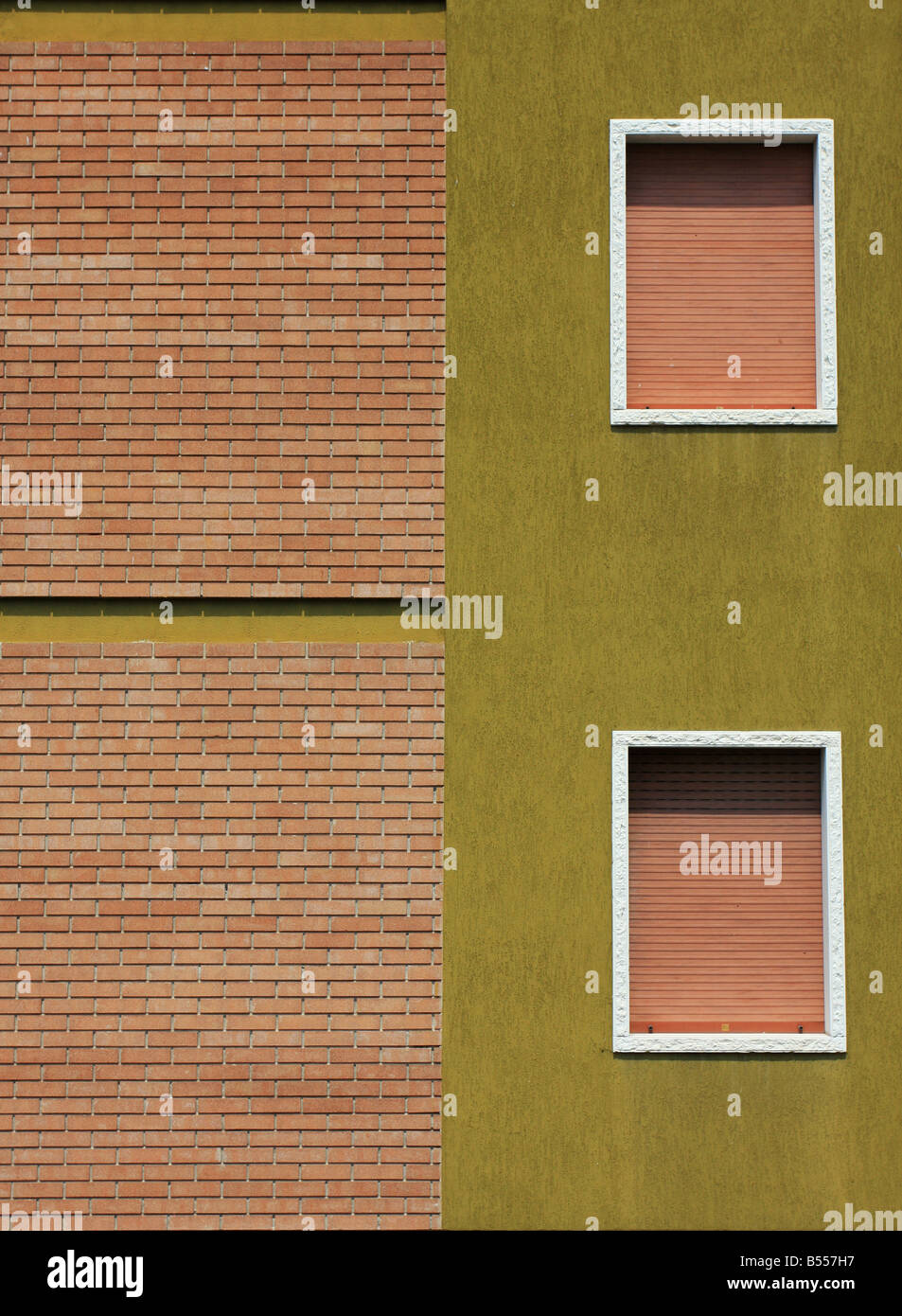 two windows on a housewall great symmetry and harmony Stock Photo - Alamy