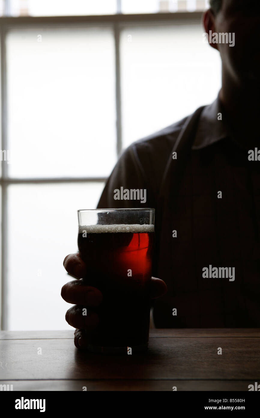 Man sitting in a pub drinking a pint of beer hi-res stock photography ...