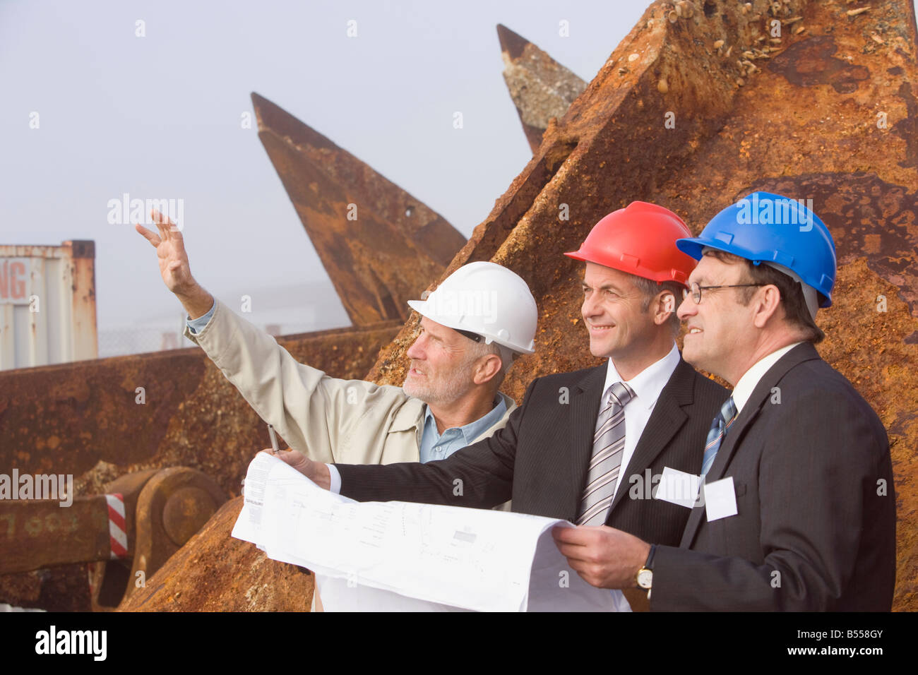 Three construction engineers standing together on survey Stock Photo ...
