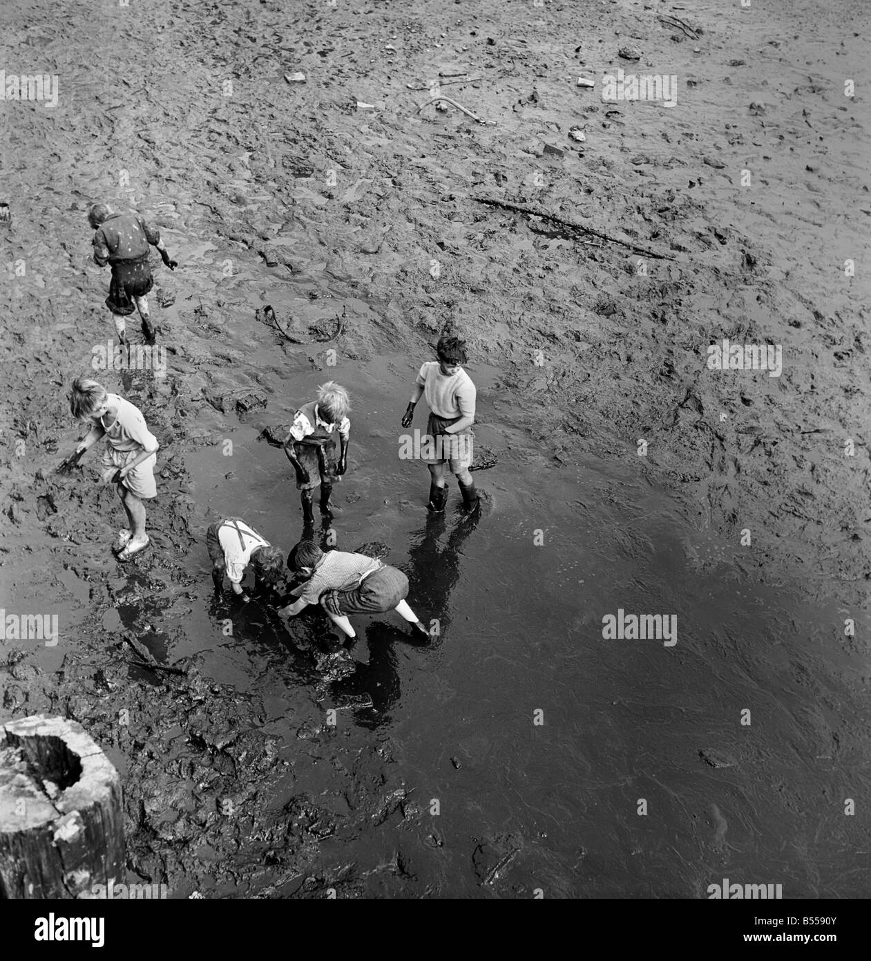 The mud-larkers: These boys at Portsmouth Harbour do a mud-lark turn to ...