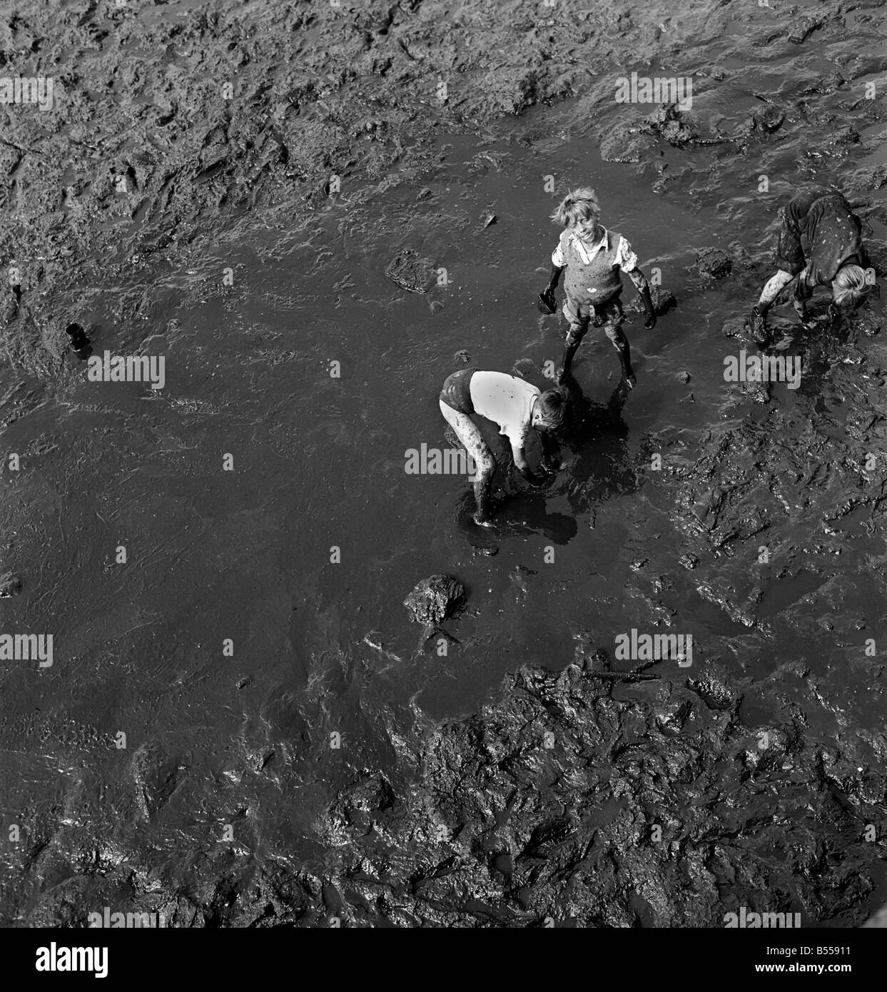 The mud-larkers: These boys at Portsmouth Harbour do a mud-lark turn to ...