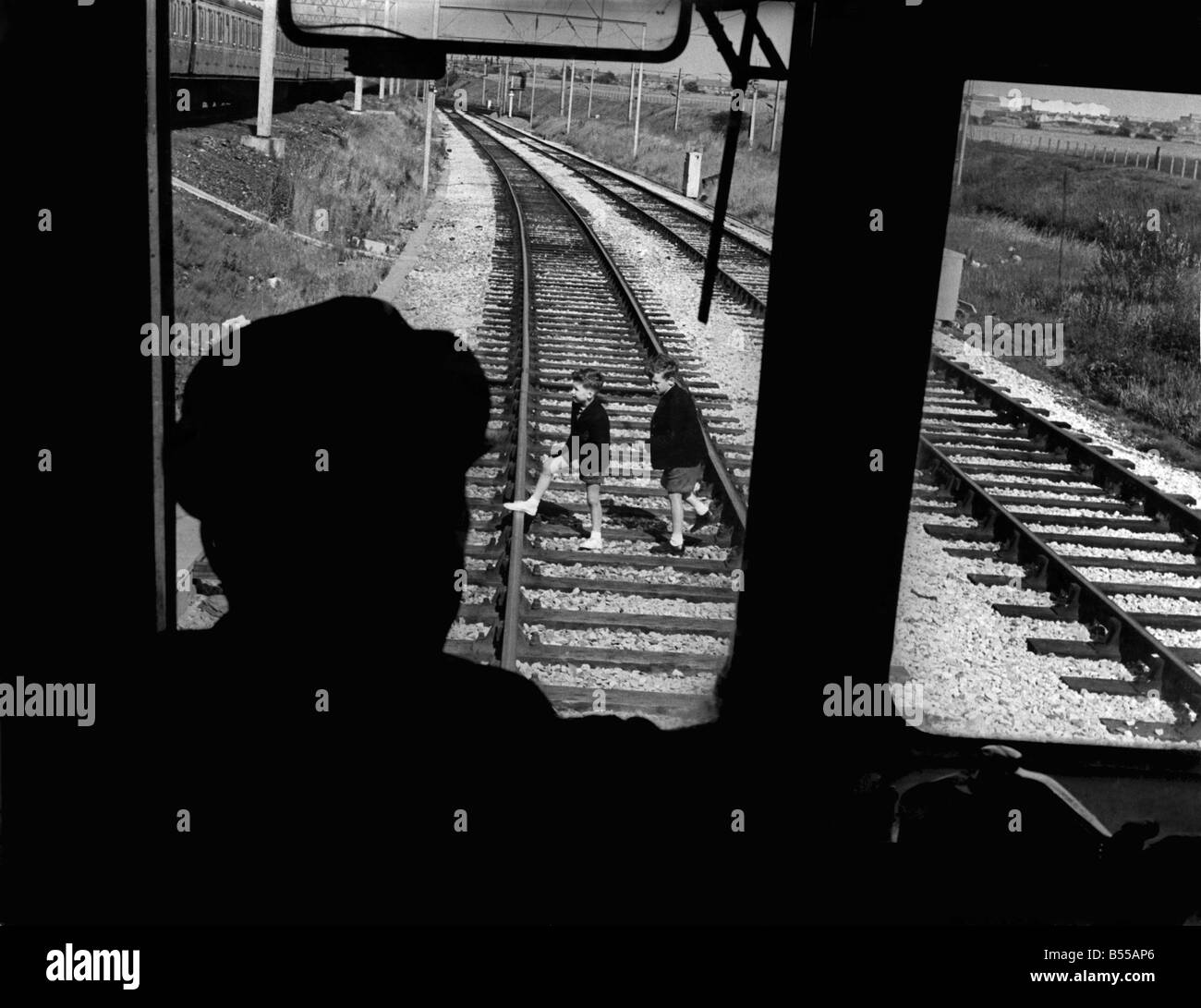 Driver George Thomas at the controls of his train as children dash ...