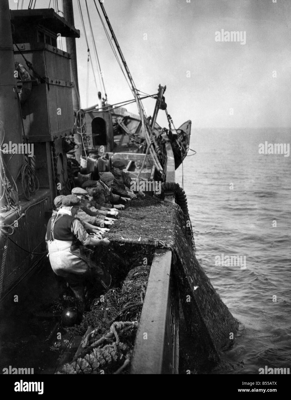 North East Coast Trawlermen heave up the fishing net in the North Sea ...