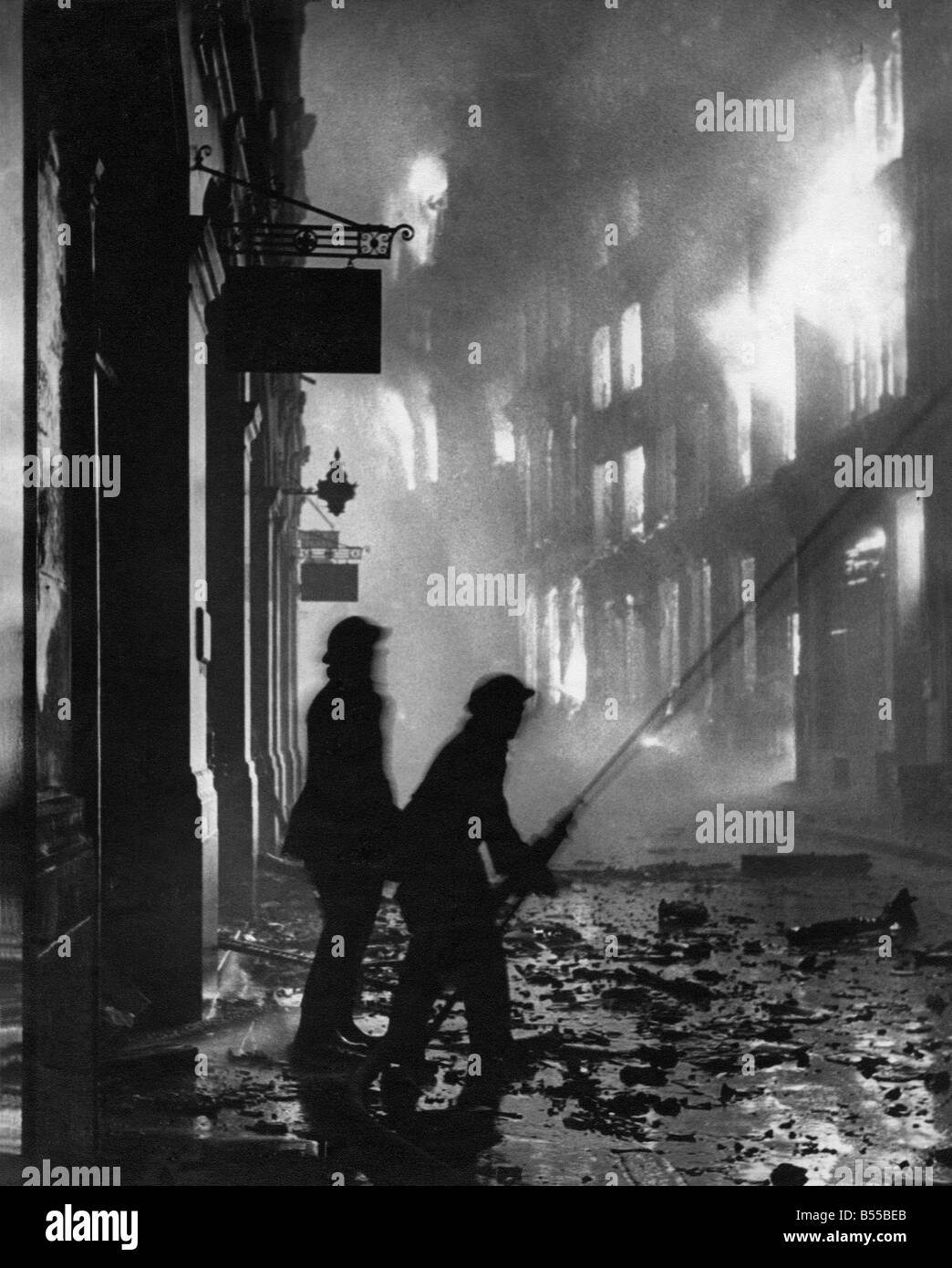World War Two. London Fire Service fighting a burning building after a ...