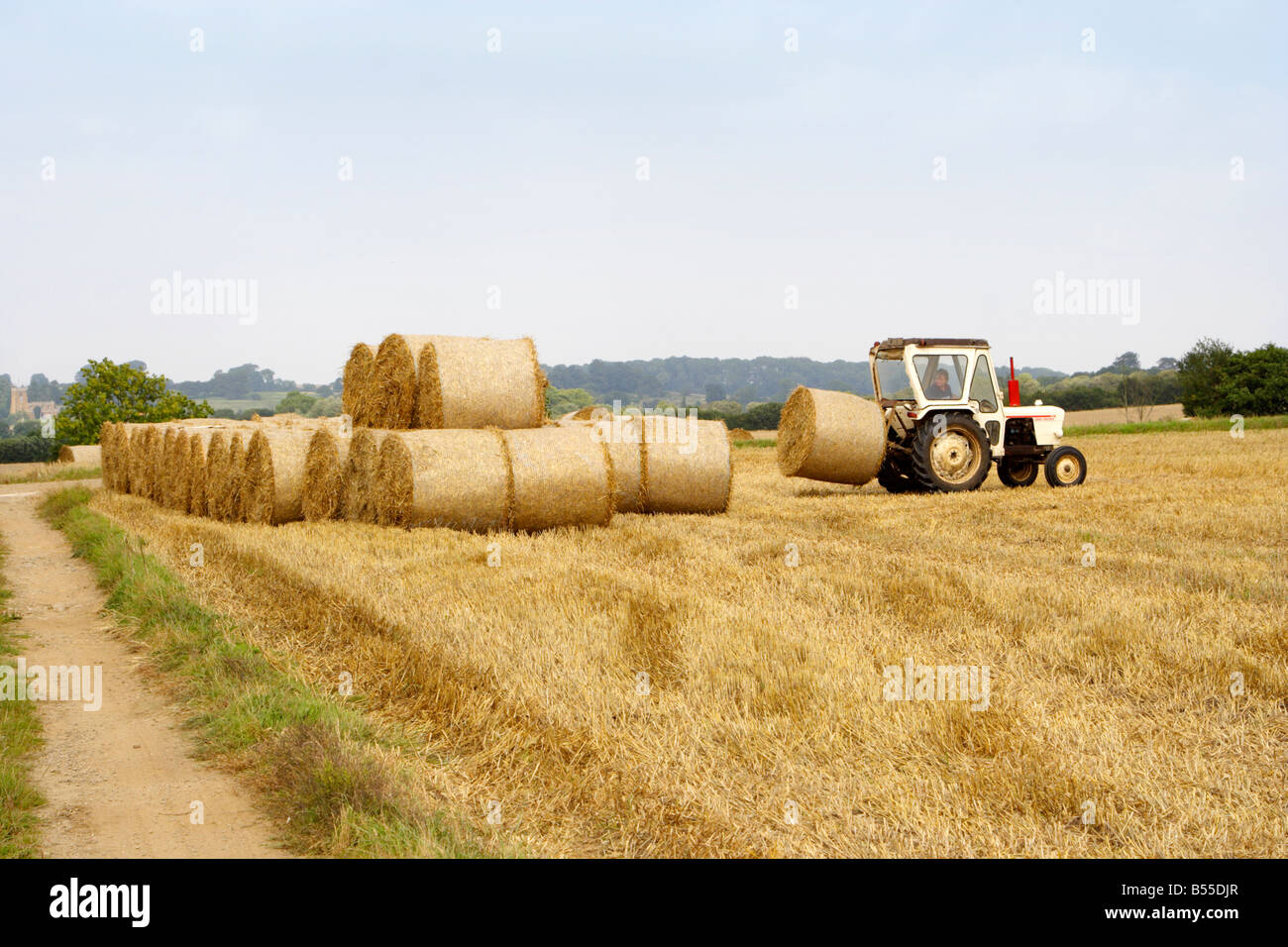tractor gathering hay bales Stock Photo - Alamy