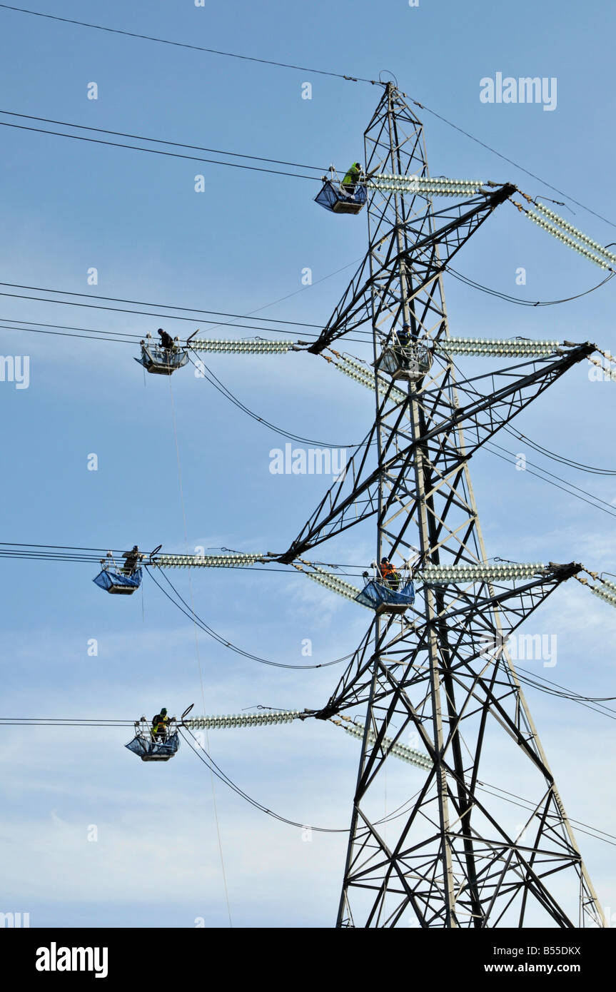 High voltage engineers working on high voltage pylons hi-res stock ...