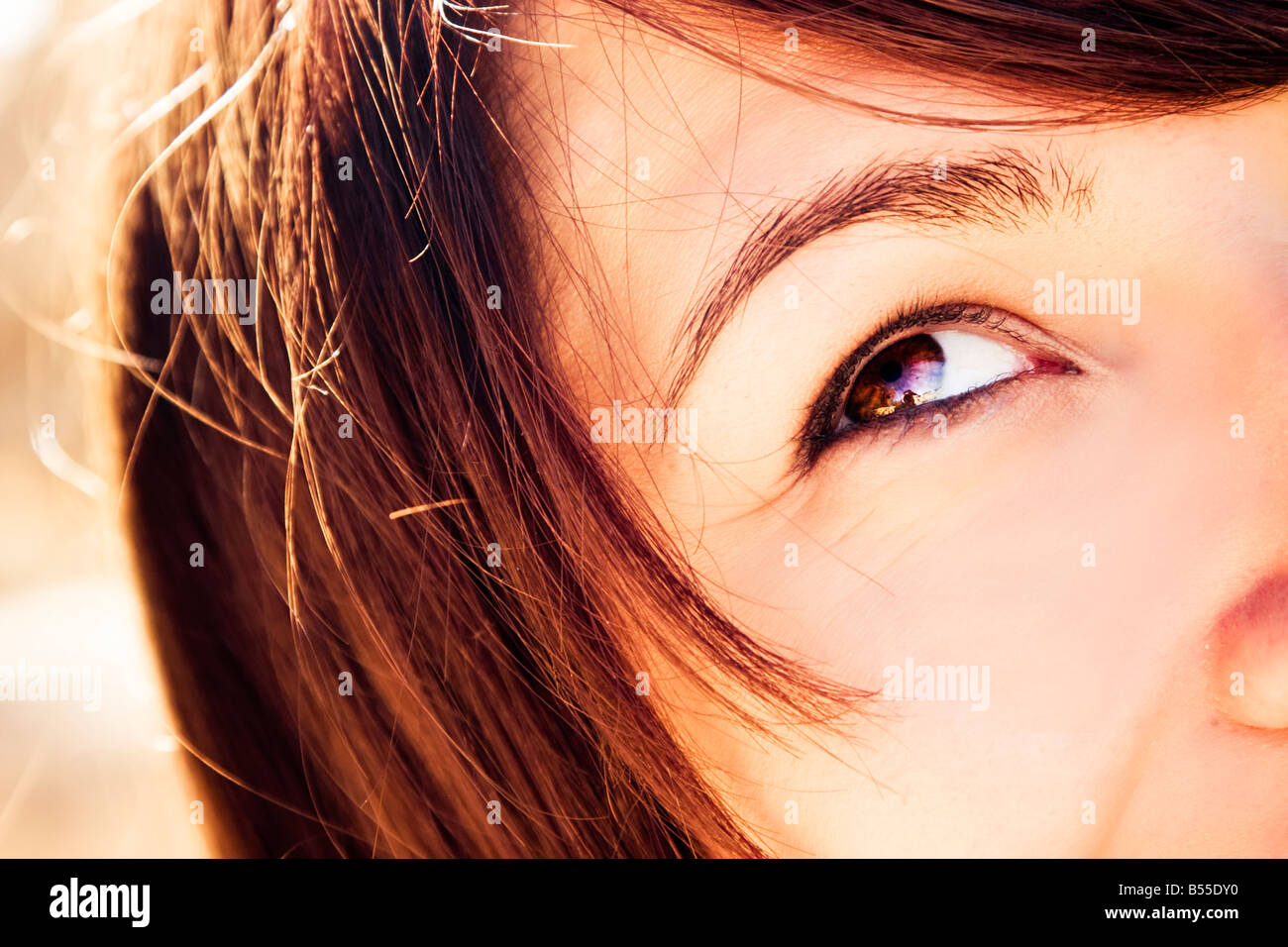 Young woman eye looking at something Stock Photo - Alamy