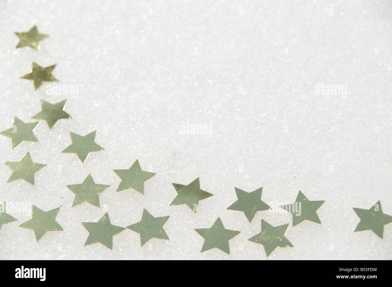 golden snow stars on a real snowy icy surface Stock Photo - Alamy