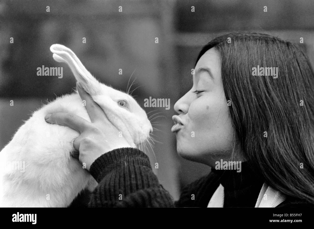 Woman holding rabbit close face Black and White Stock Photos & Images ...
