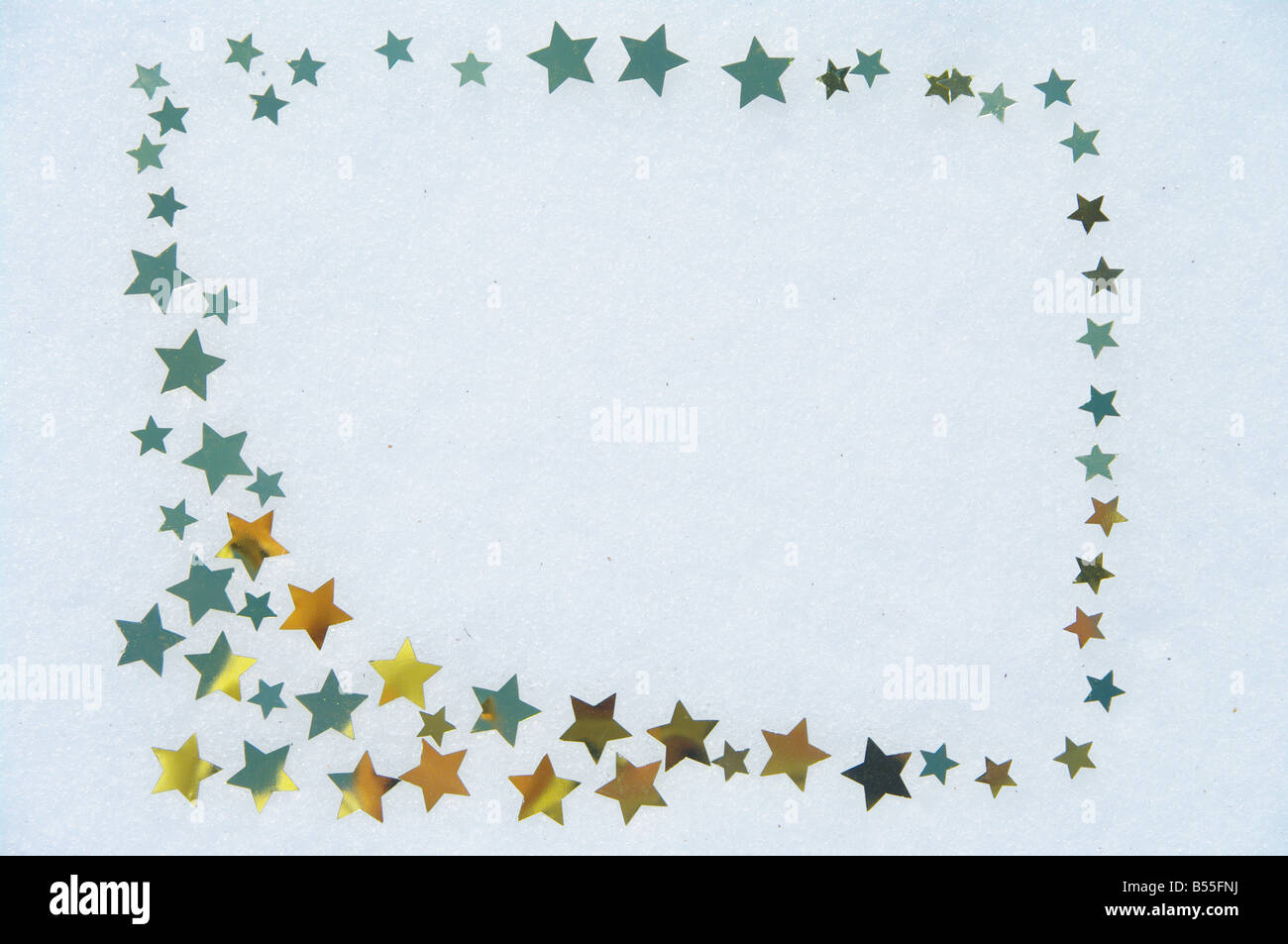 golden snow stars on a real snowy icy surface Stock Photo - Alamy