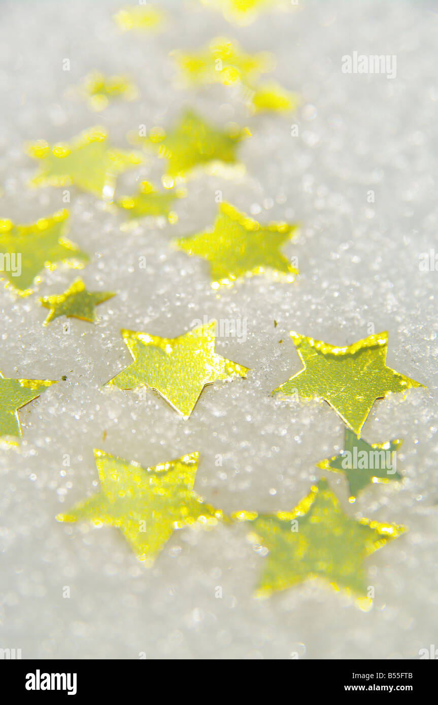 golden snow stars on a real snowy icy surface Stock Photo - Alamy