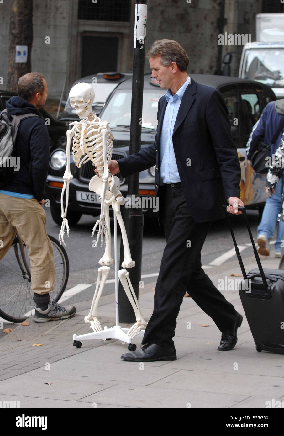 A man walking down the street with a skeleton Stock Photo - Alamy