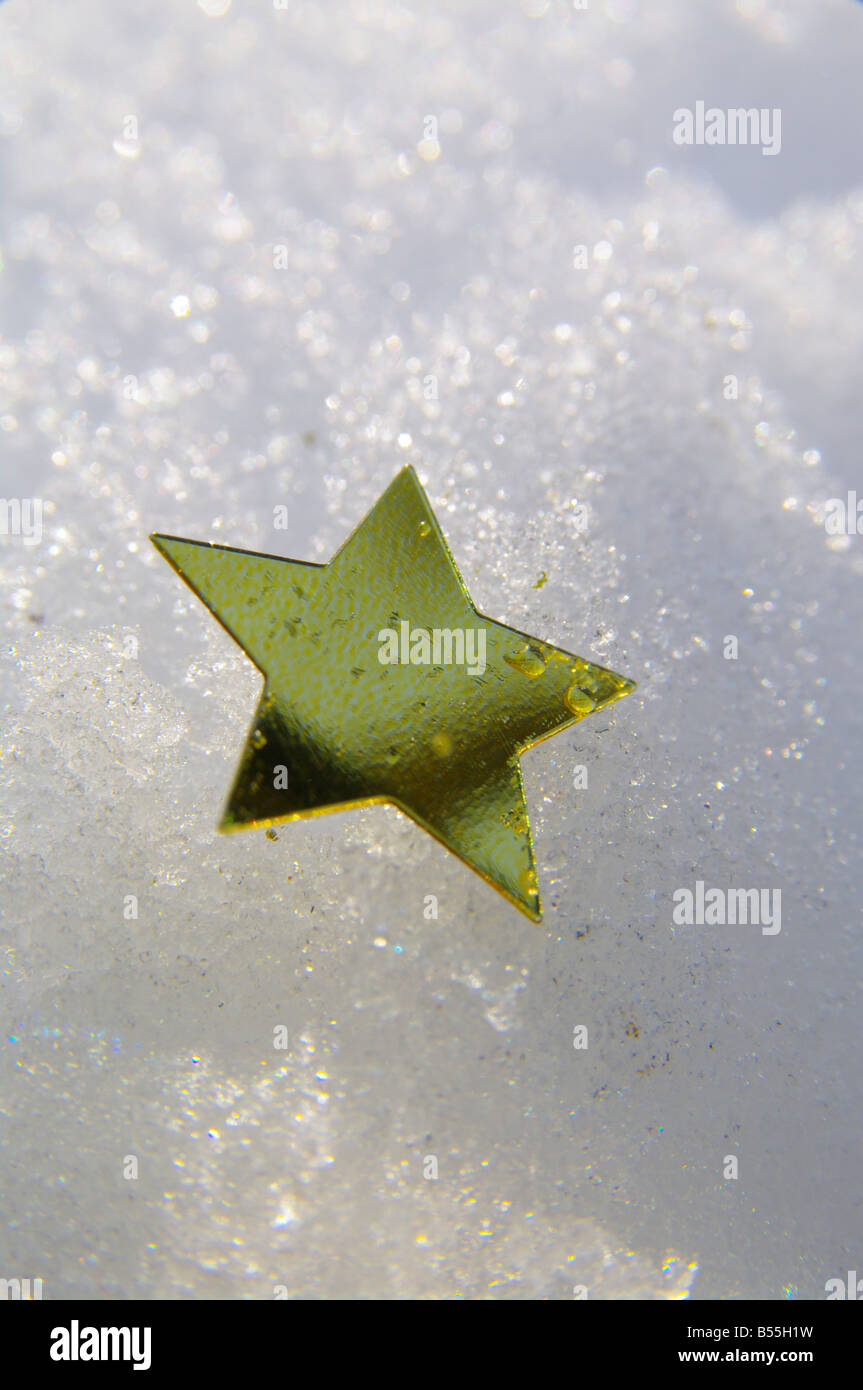 golden snow stars on a real snowy icy surface Stock Photo - Alamy